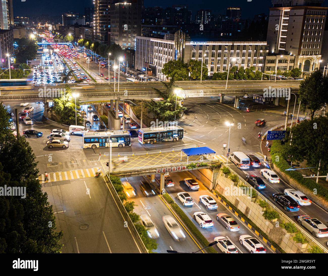 A nighttime aerial photo of a roundabout filled with vehicles, where ...