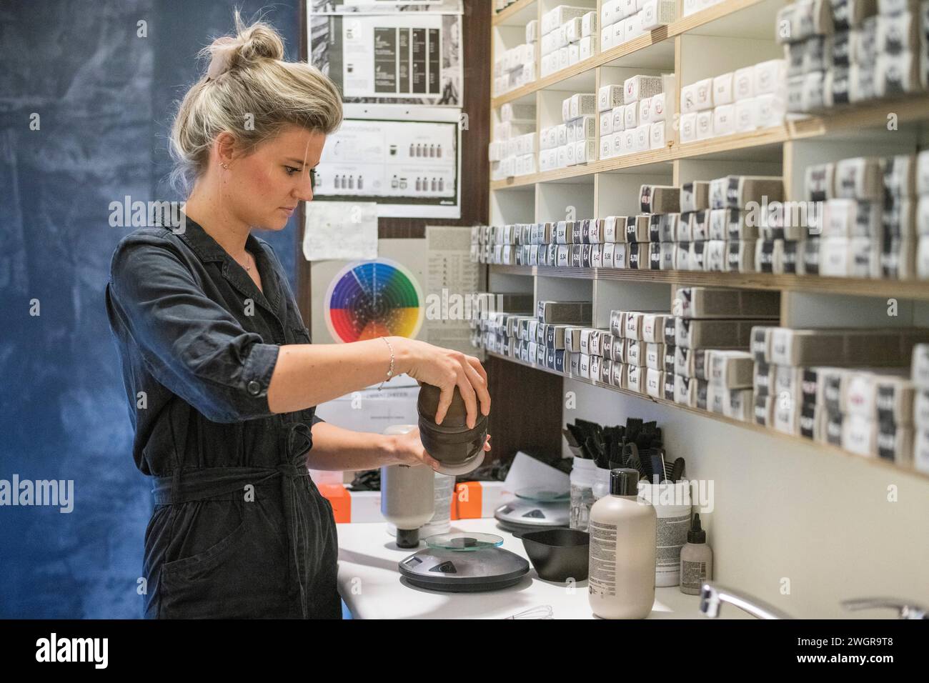 Hair stylist preparing colour for her clients blonde hair Stock Photo ...