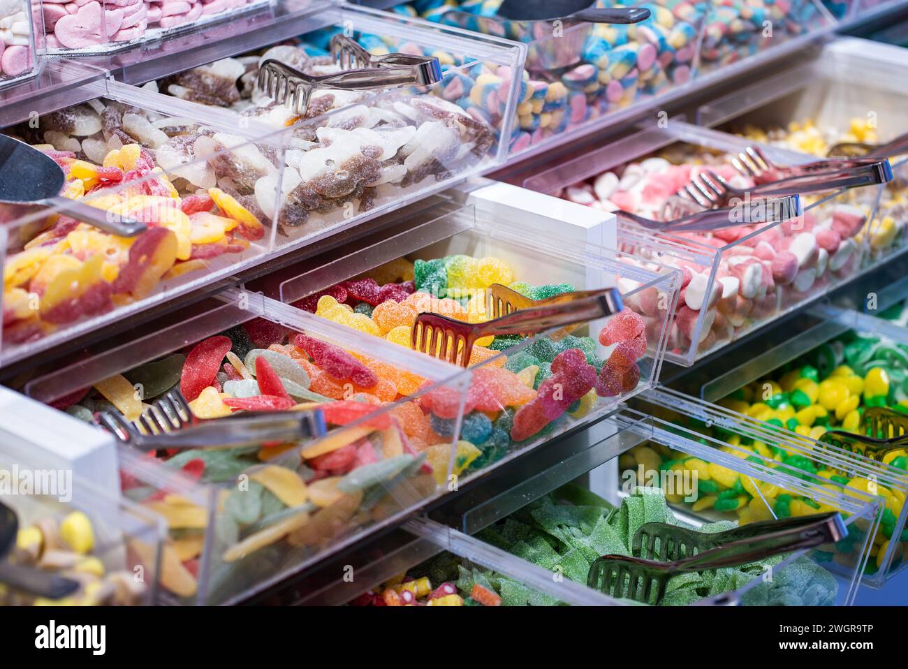 showcase of candy shop, transparent container with various sweets ...