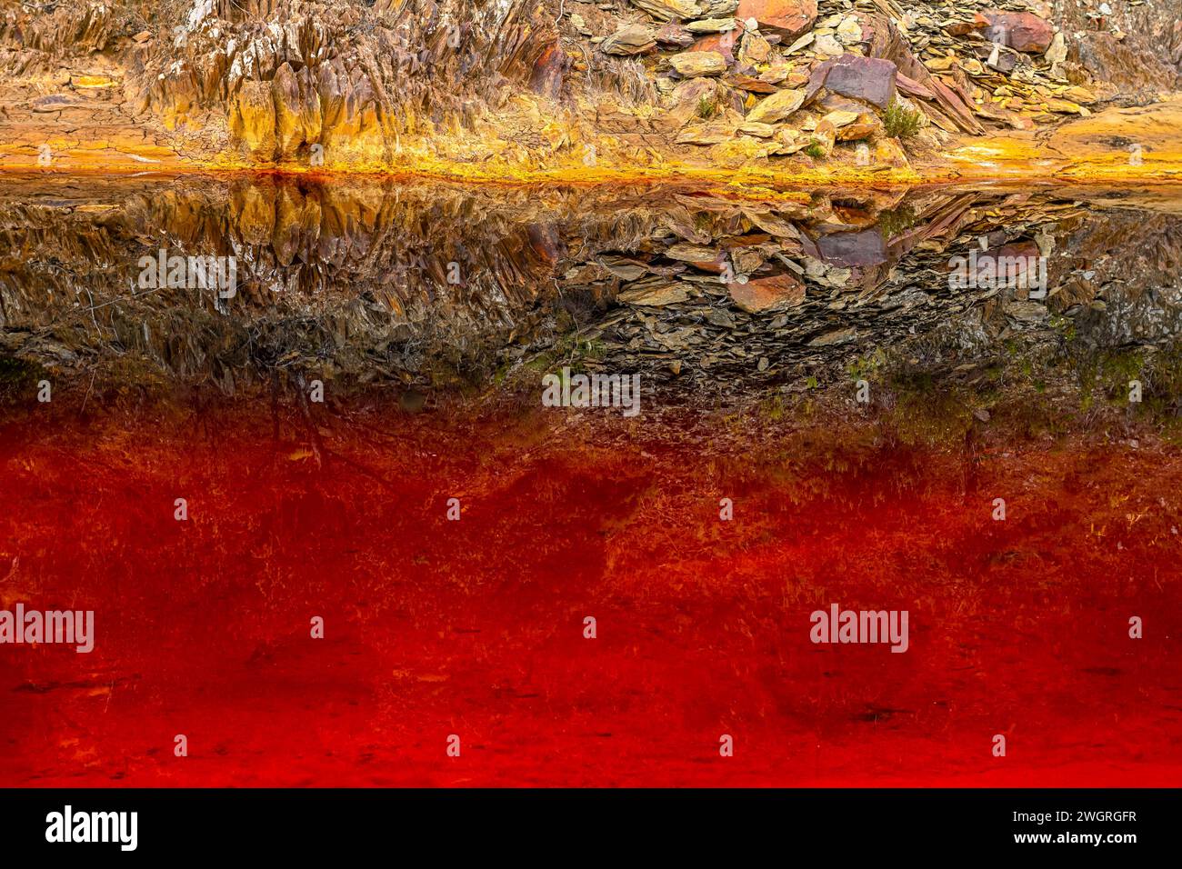 The waters of Rio Tinto create a stunning reflection of the red-tinted ...