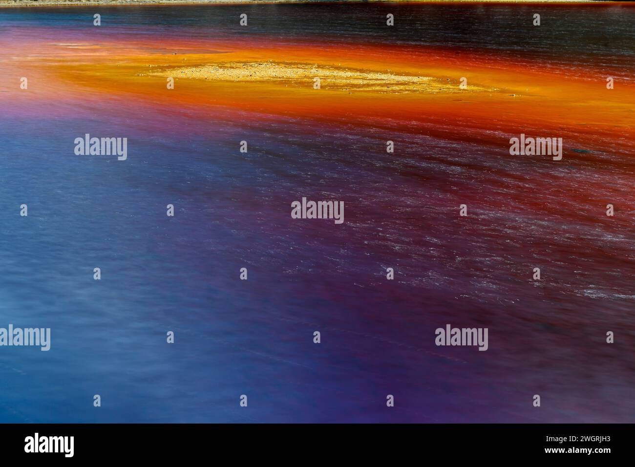 Rich, rust-colored waters of Rio Tinto reflecting the verdant riverside ...