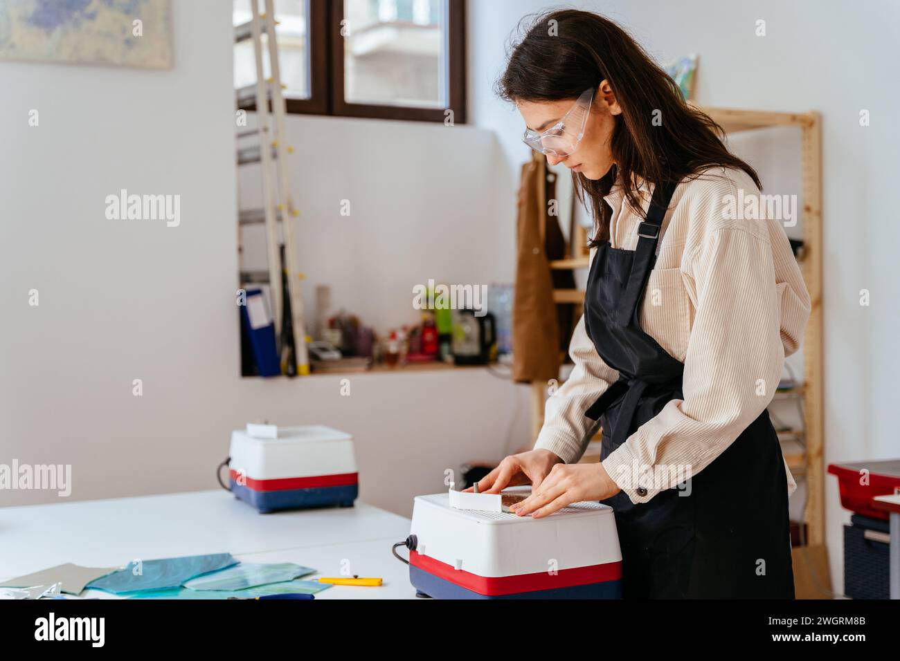 Glass grinding in workshop. Production of stained glass. Handicraft ...