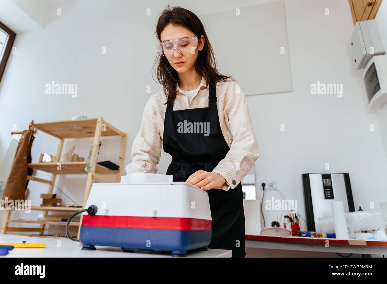 Glass grinding in workshop. Production of stained glass. Handicraft ...