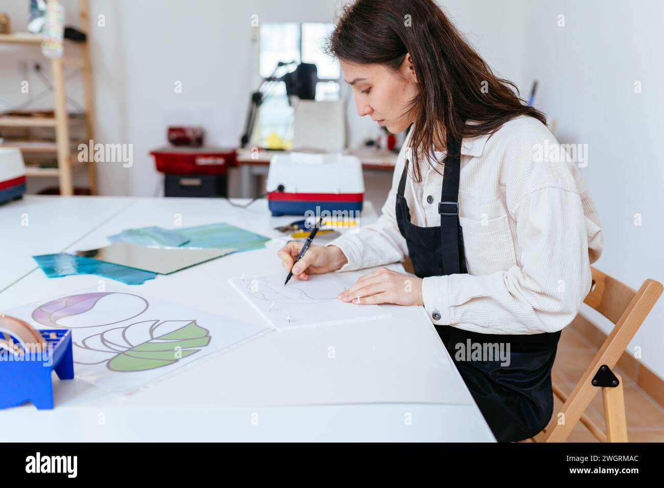 Young female artist working with Sketch for the stained glass windows ...