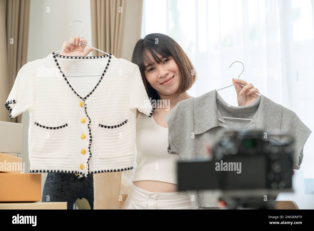 Young woman selling clothes online Stock Photo - Alamy