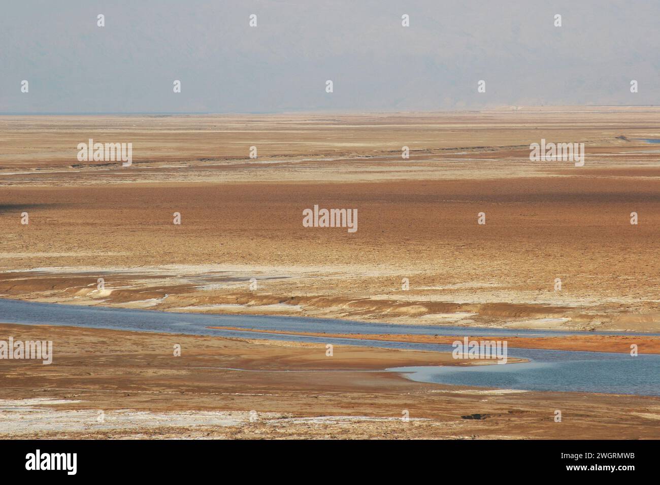 A sinkhole caused by the receding water level of the Dead Sea. A hot ...