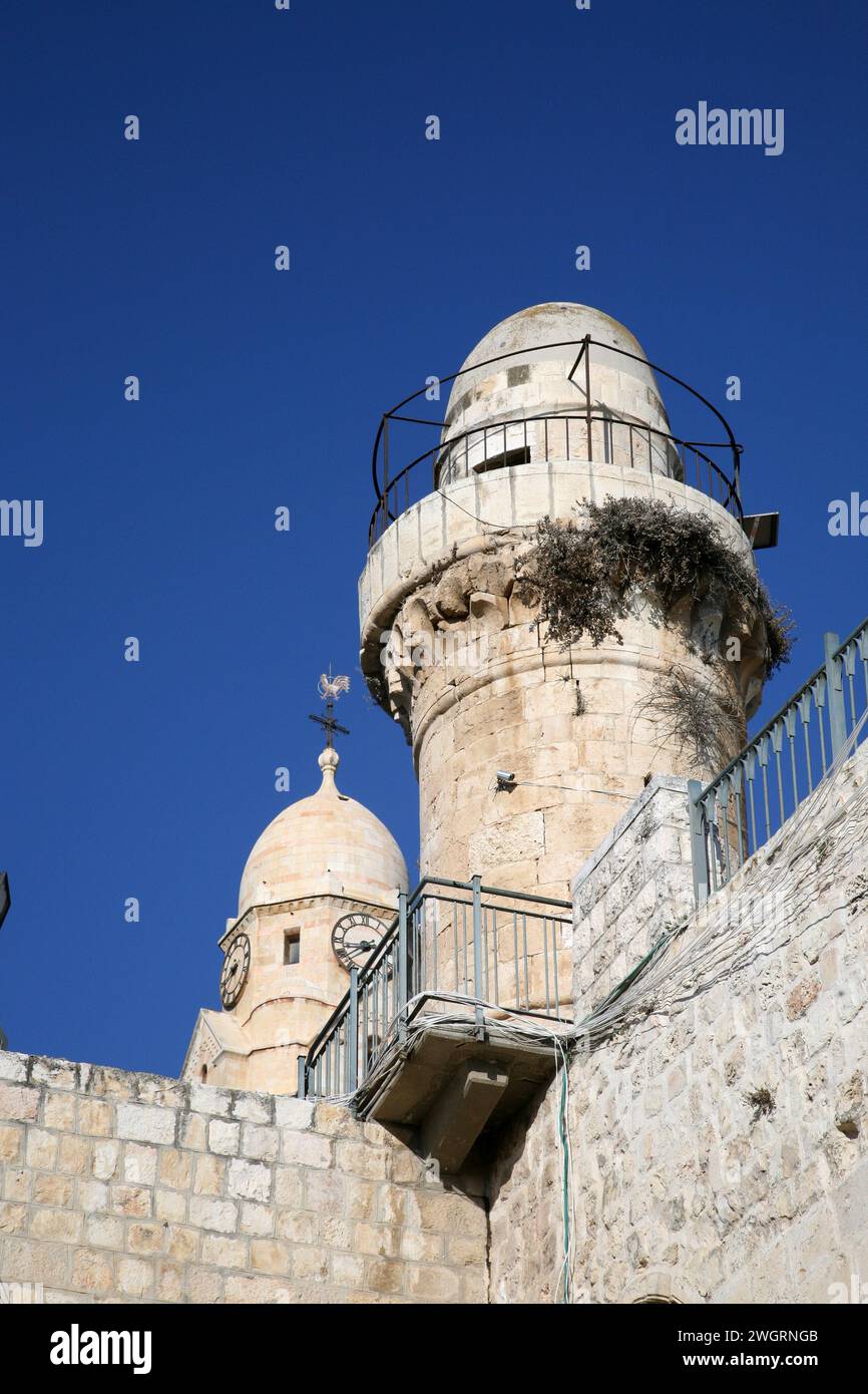 The Benedictine Dormition Abbey bell tower stands parallel to a Muslim ...