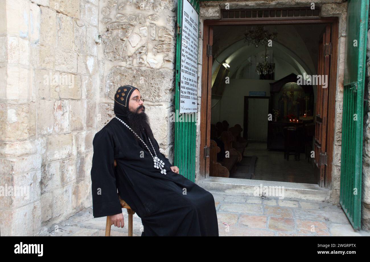 Courtyard of the Church of the Holy Sepulchre, Coptic monk sitting in ...