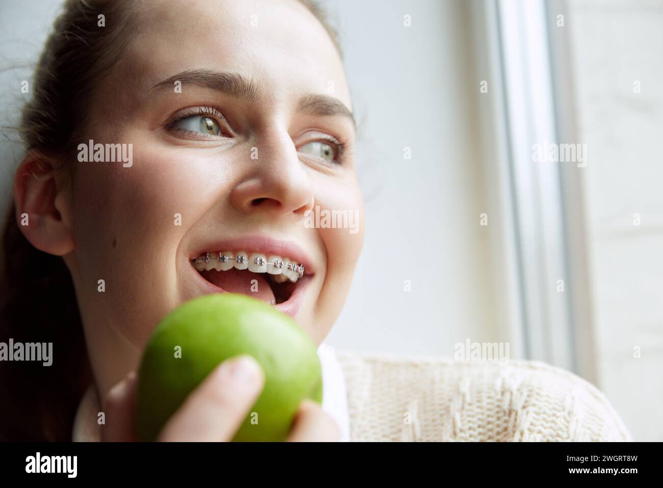 Braces and bites. Close up portrait of young woman in dental braces ...