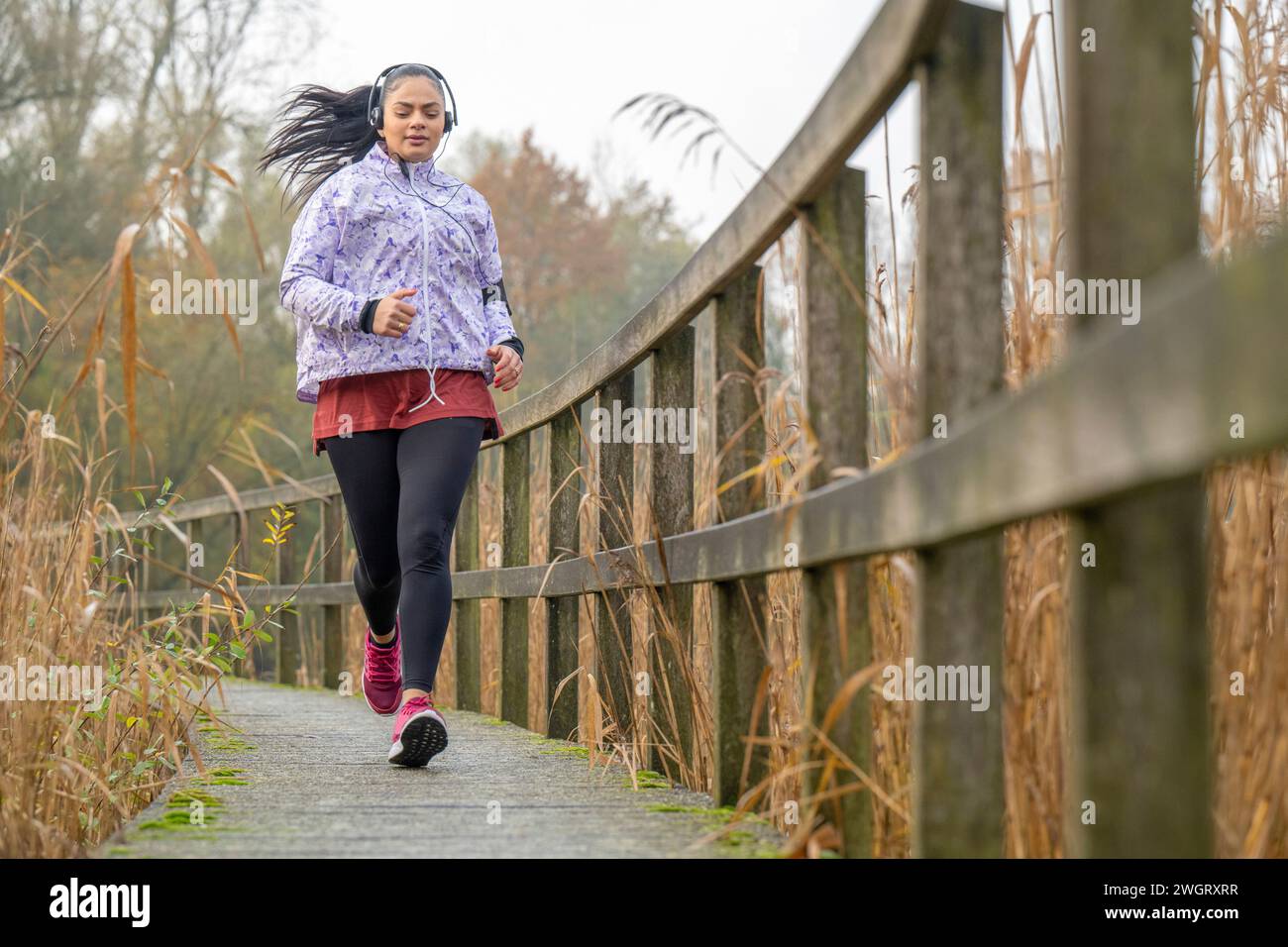 Healthy fit woman running through the park keeping fit Stock Photo - Alamy