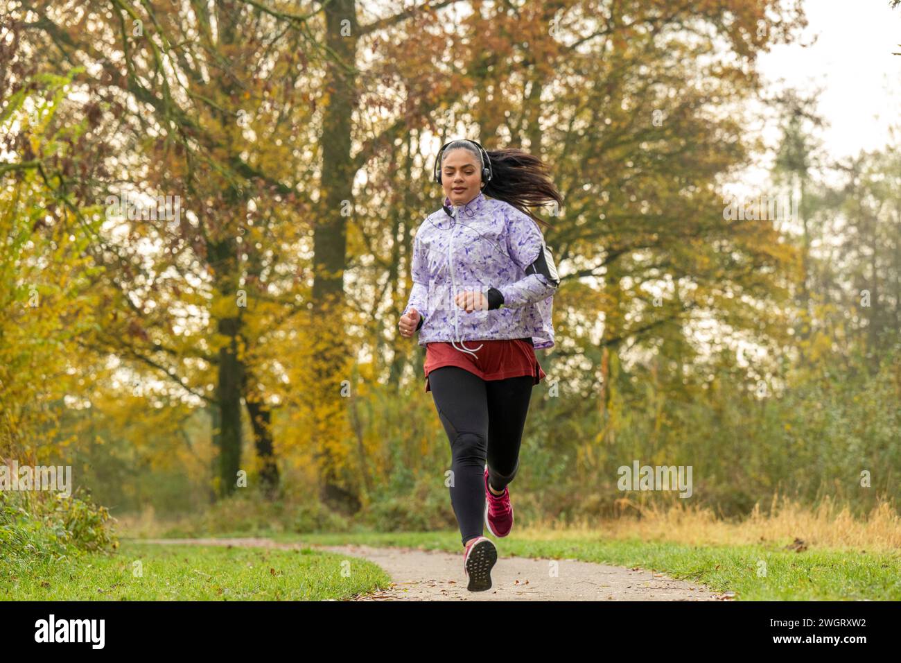 Healthy fit woman running through the park keeping fit Stock Photo - Alamy