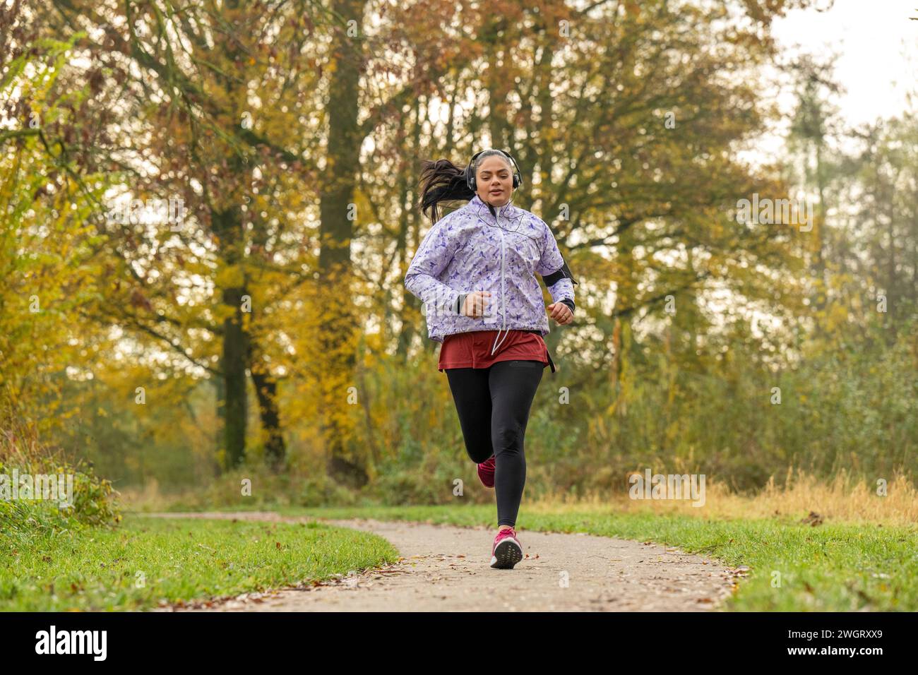 Healthy fit woman running through the park keeping fit Stock Photo - Alamy