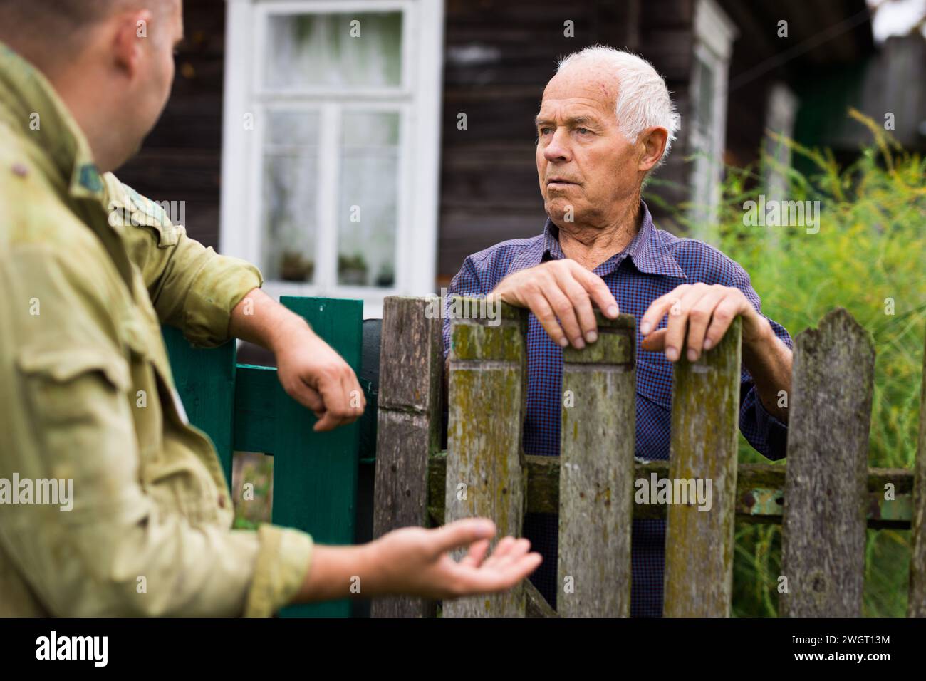 Old man talking with his neighbour Stock Photo - Alamy