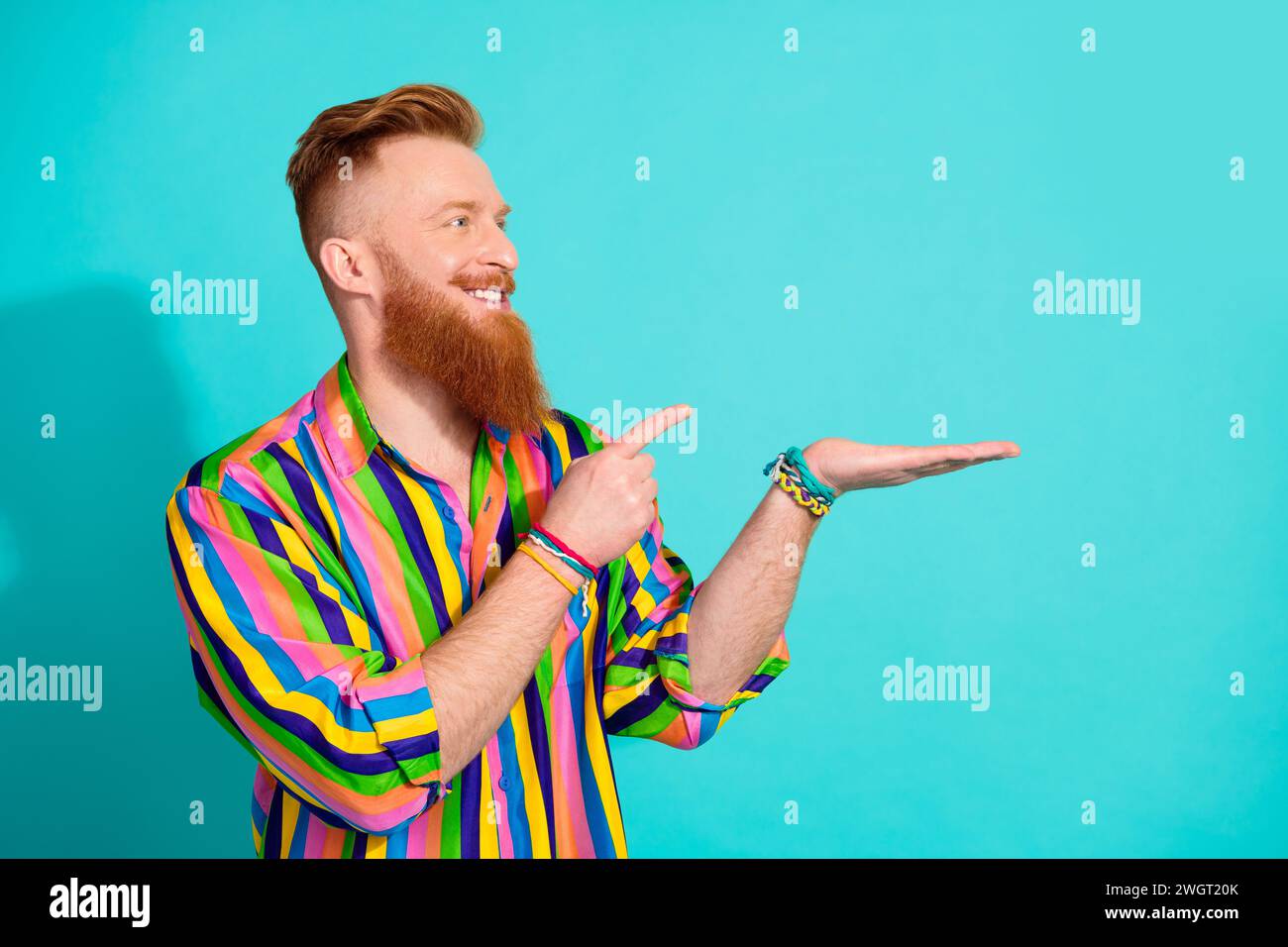 Photo of irish man promoter in striped shirt direct finger to his hand ...