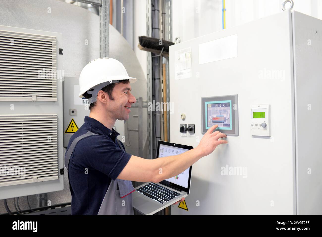 workers in an industrial plant check the systems with modern technology ...