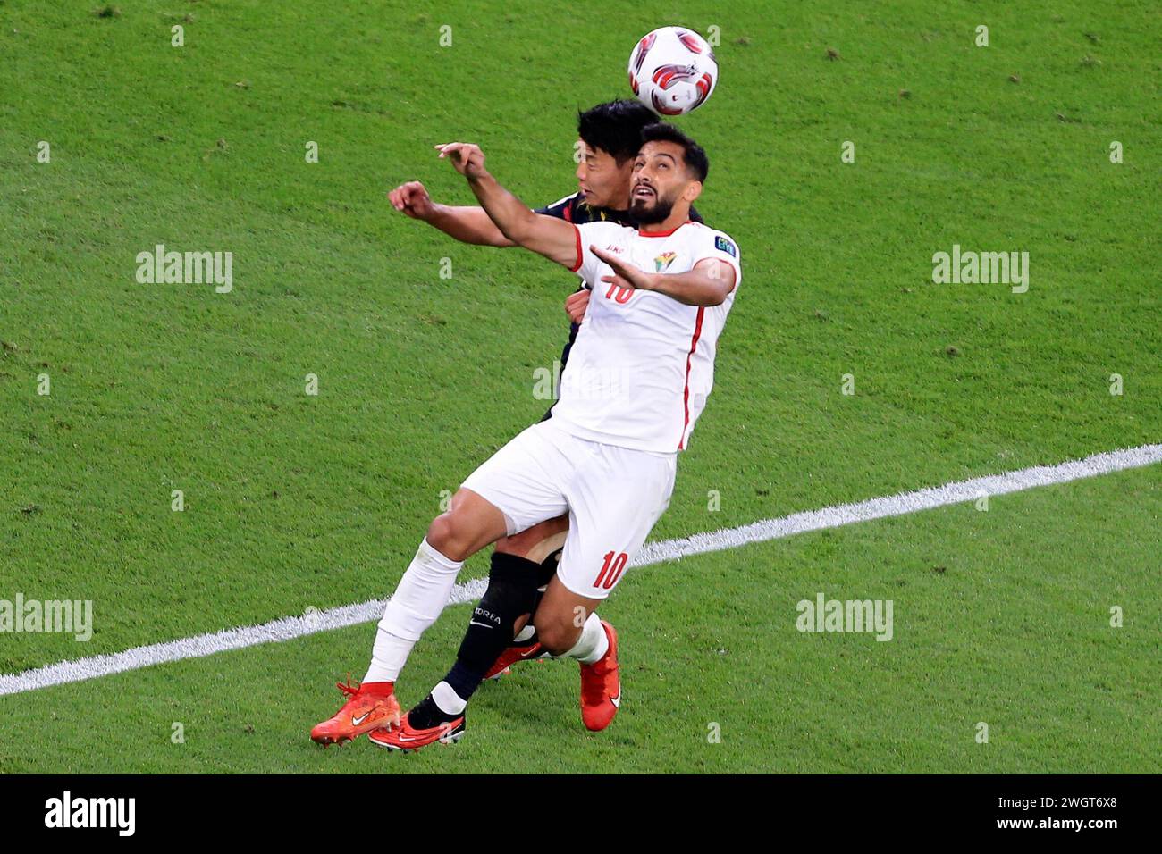 South Korea's Hwang Hee-chan, left, and Jordan's Mousa Altamari go for ...