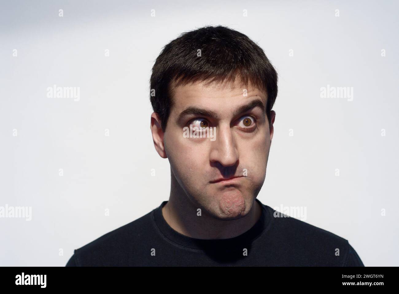 Adult man grimacing with his face and gesturing with his hands Stock ...