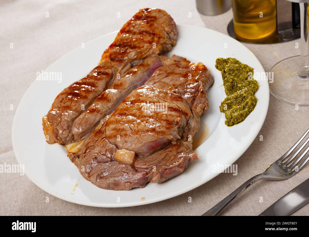 Fried beef entrecote with pesto Stock Photo - Alamy