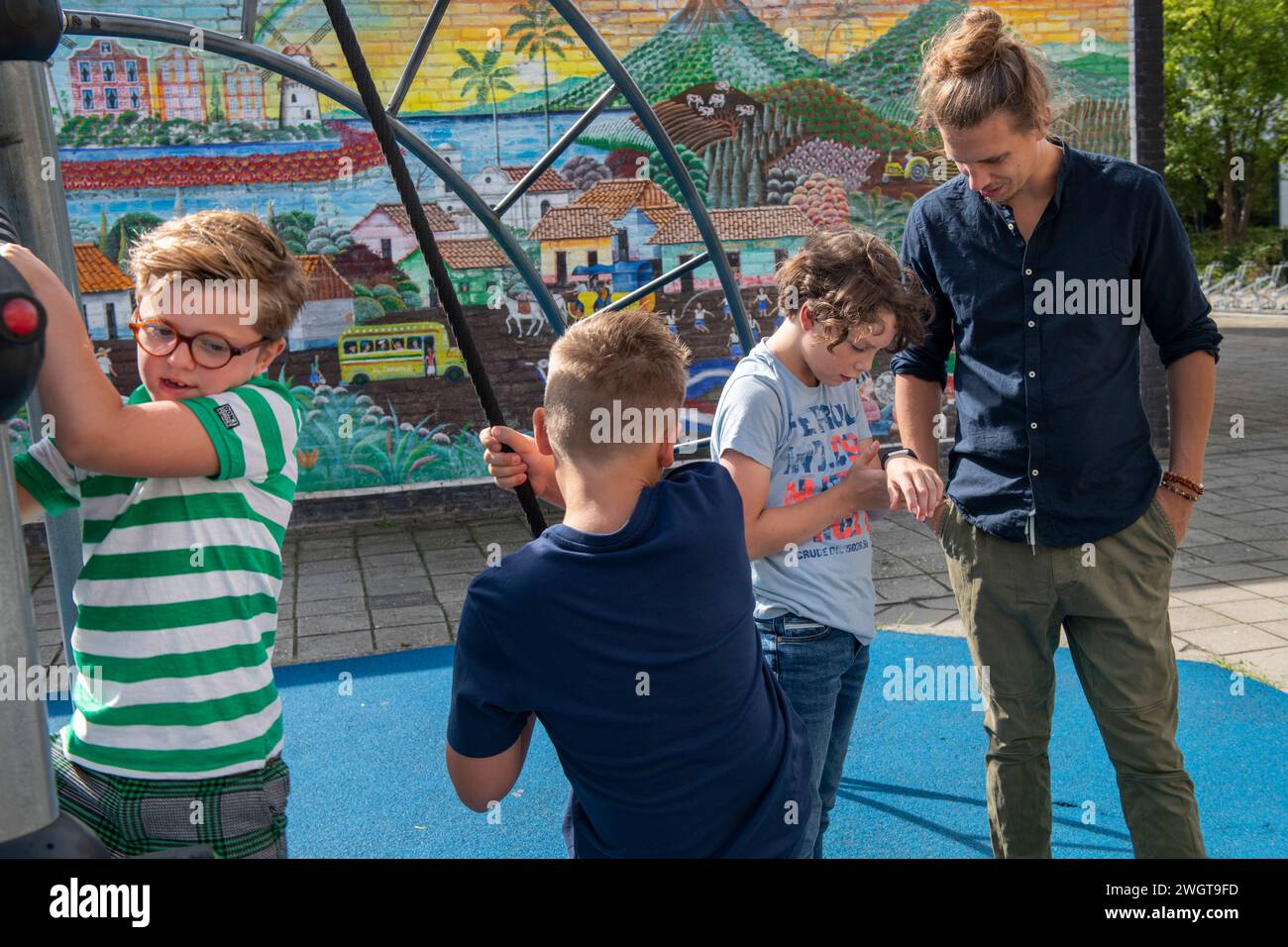 Young group of boys being supervised by their teacher in the school ...