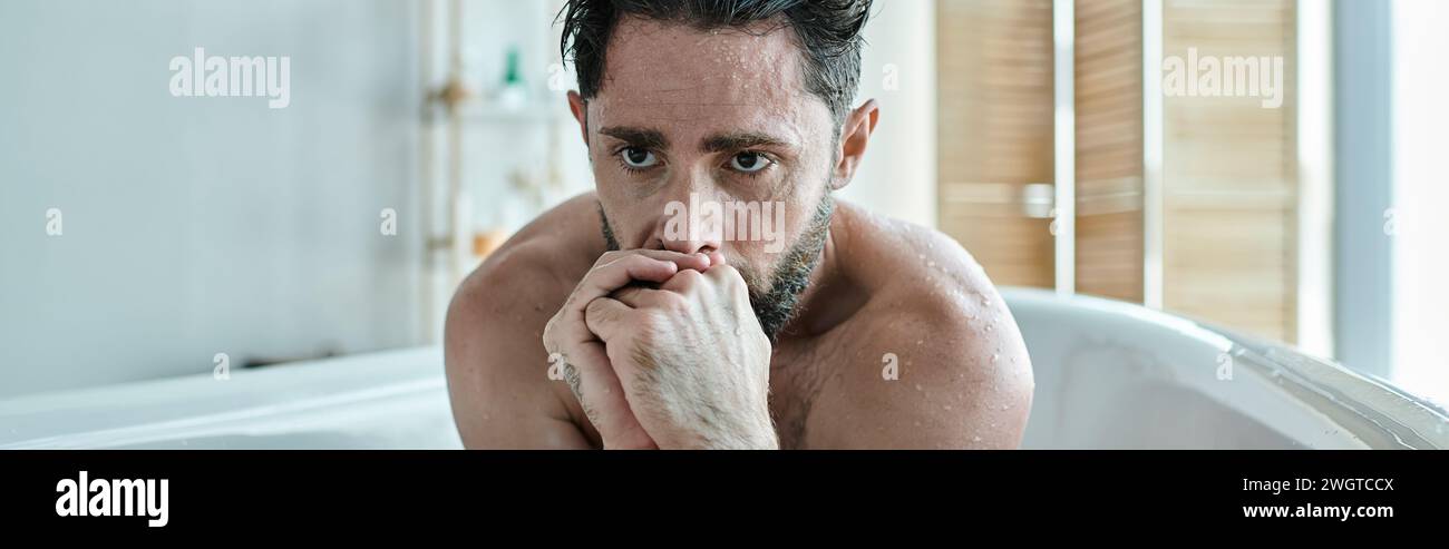 sick man sitting in bathtub with hands near face during breakdown ...