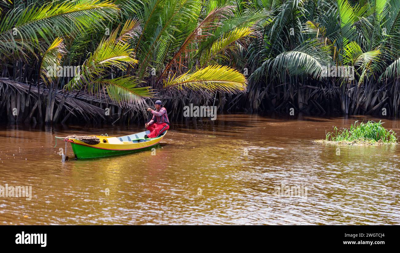 Local fisherman in his canoo on Sekonyer River, Tanjung Puting National ...