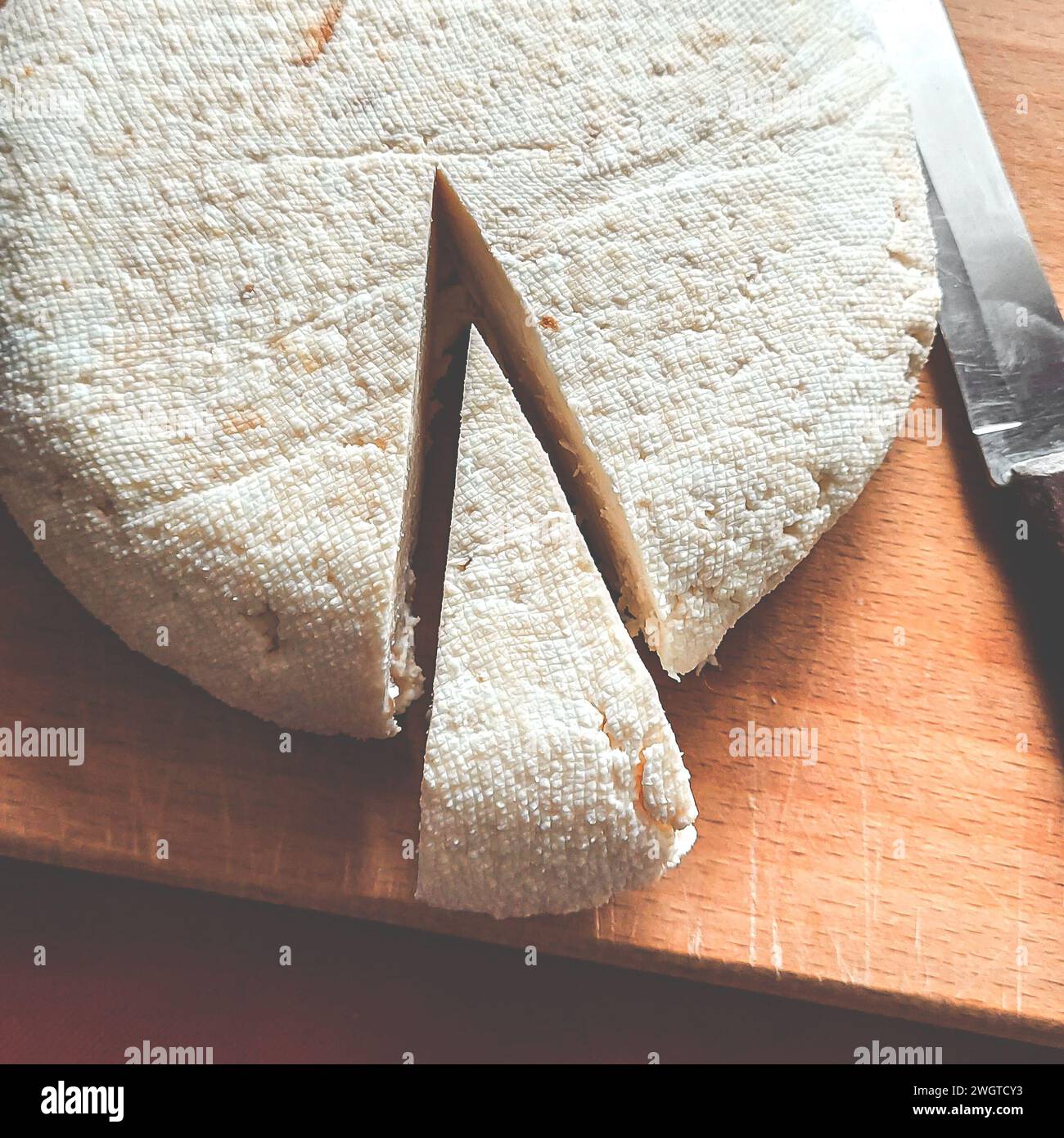 A wheel of homemade hard cheese. Cheese Stock Photo - Alamy