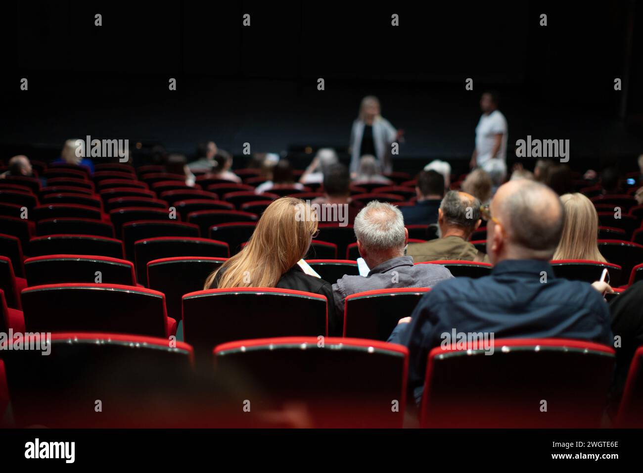 People in the cinema auditorium taking seats Stock Photo - Alamy