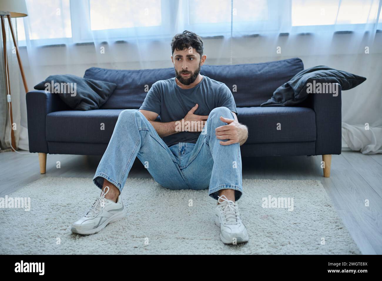 bearded suffering man in casual home wear having severe panic attack ...