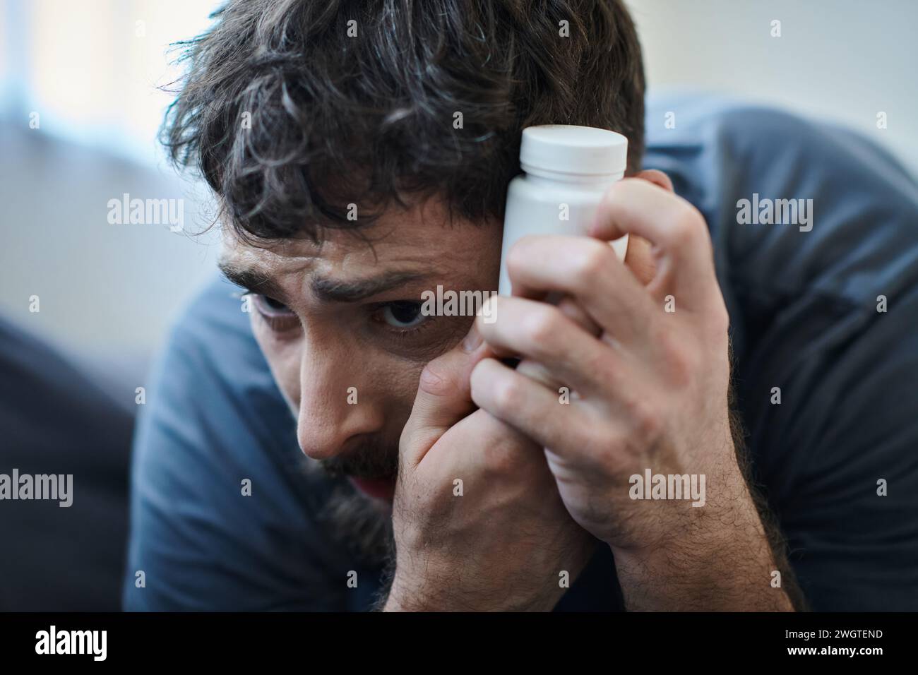 desperate man holding pills during depressive episode with self harm ...