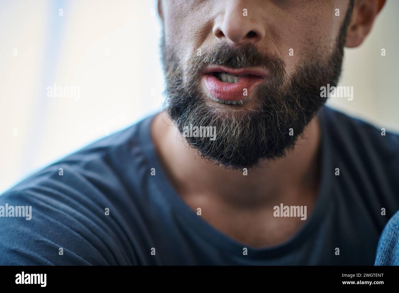 cropped view of traumatized man biting his lips during depressive ...