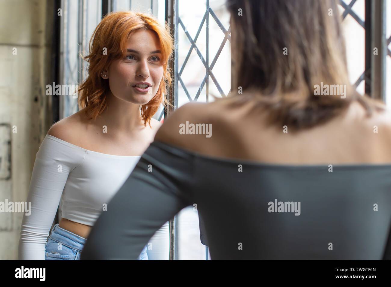 two girlfriends having a secret conversation Stock Photo - Alamy
