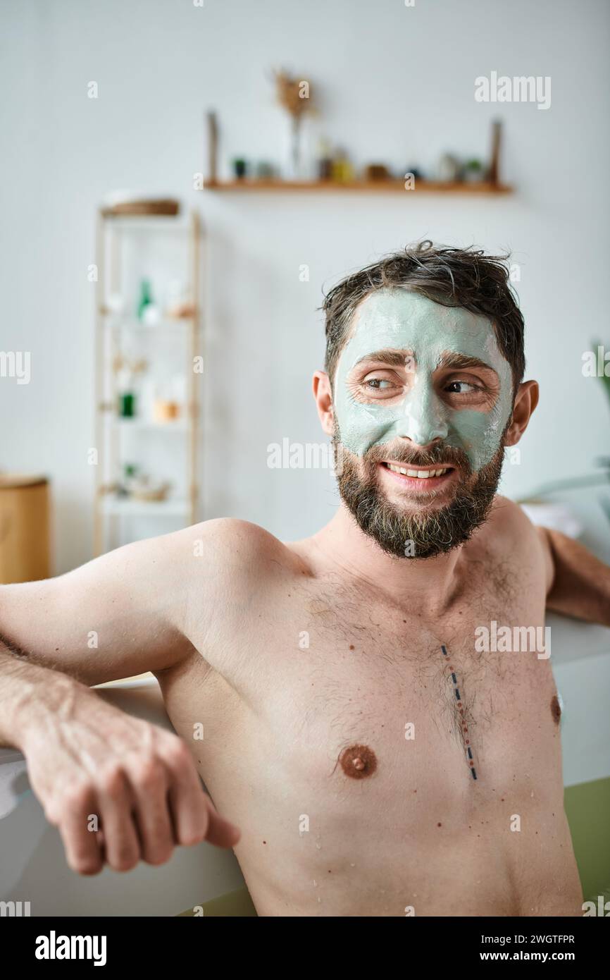 joyous handsome man with beard and face mask chilling in his bathtub ...