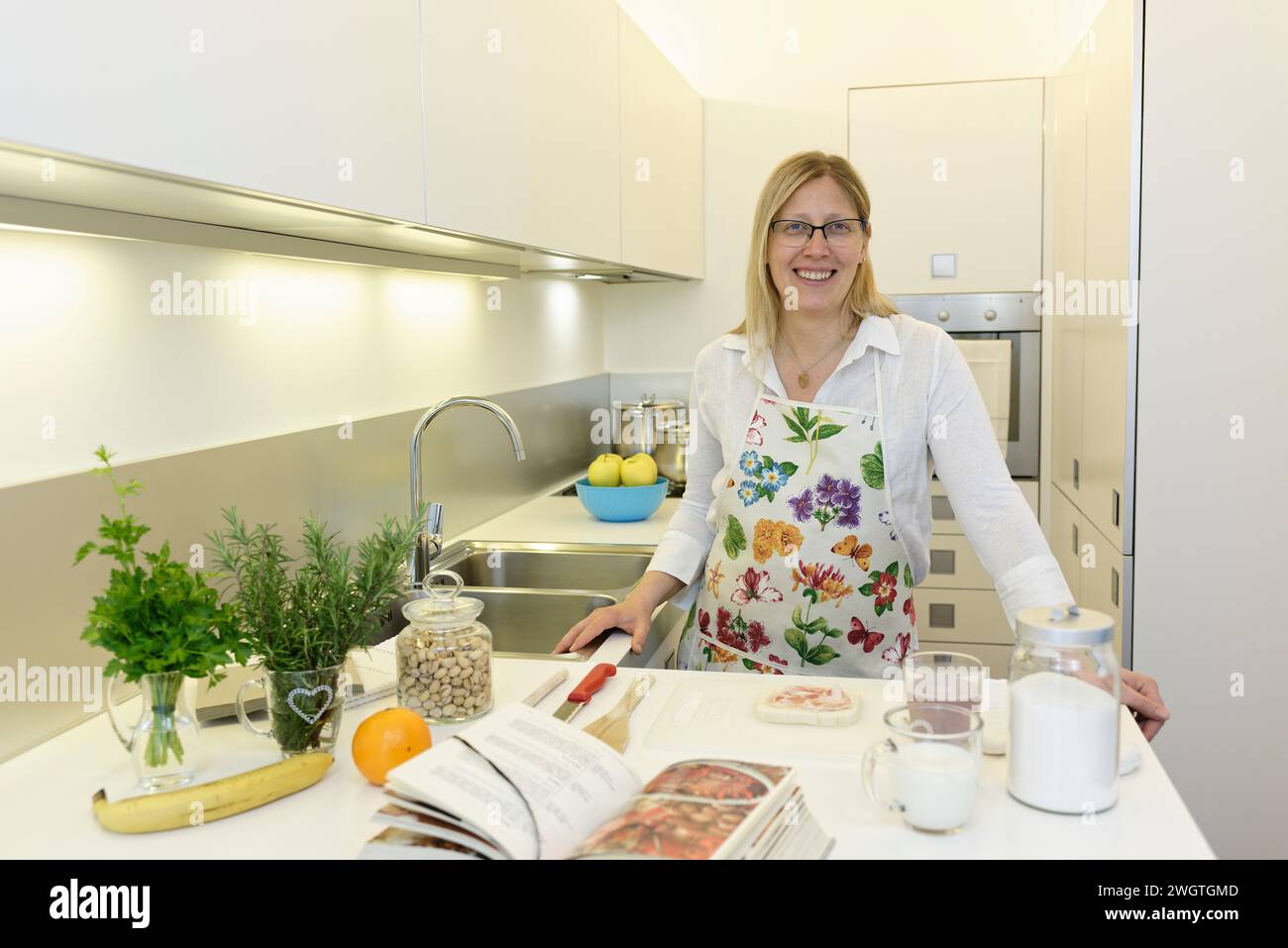 Blonde woman cooking indoors, Milano, Italy Stock Photo - Alamy