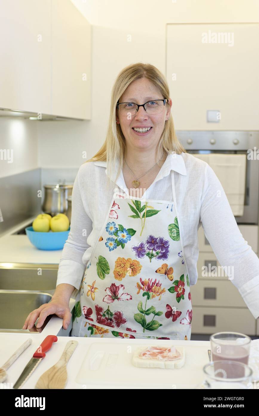 Blonde woman cooking indoors, Milano, Italy Stock Photo - Alamy