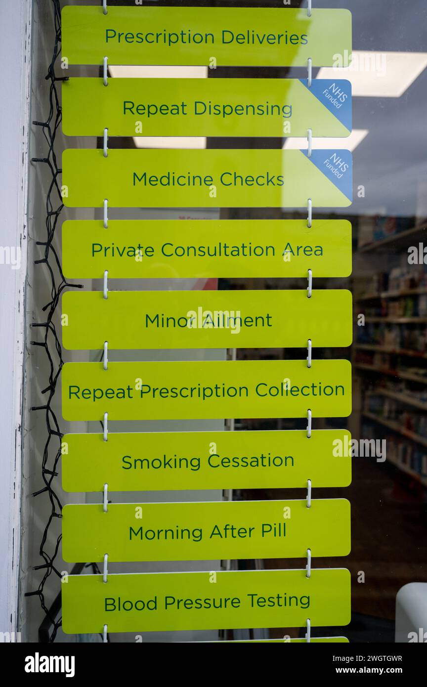 Signs in a chemists of pharmacy shop window offering private healthcare ...