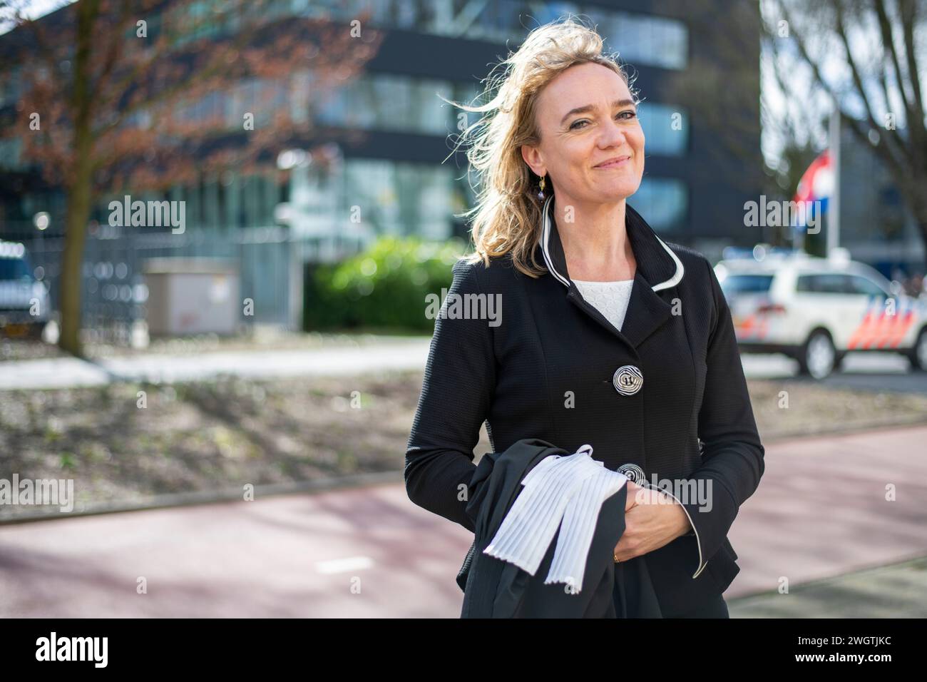 Standing smiling looking building exterior hi-res stock photography and ...