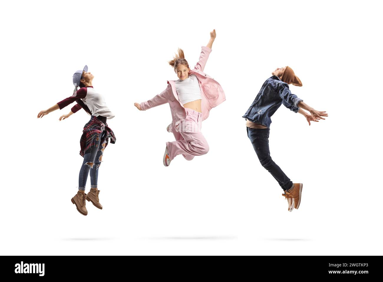 Group of young people performing dance jumps isolated on white ...