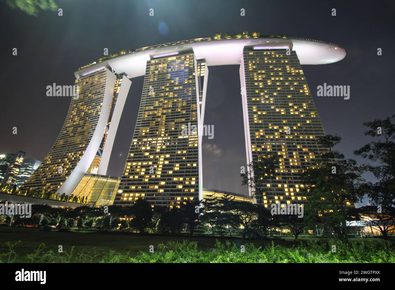 The triple towers of the Marina Bay Sands hotel are fully illuminated ...