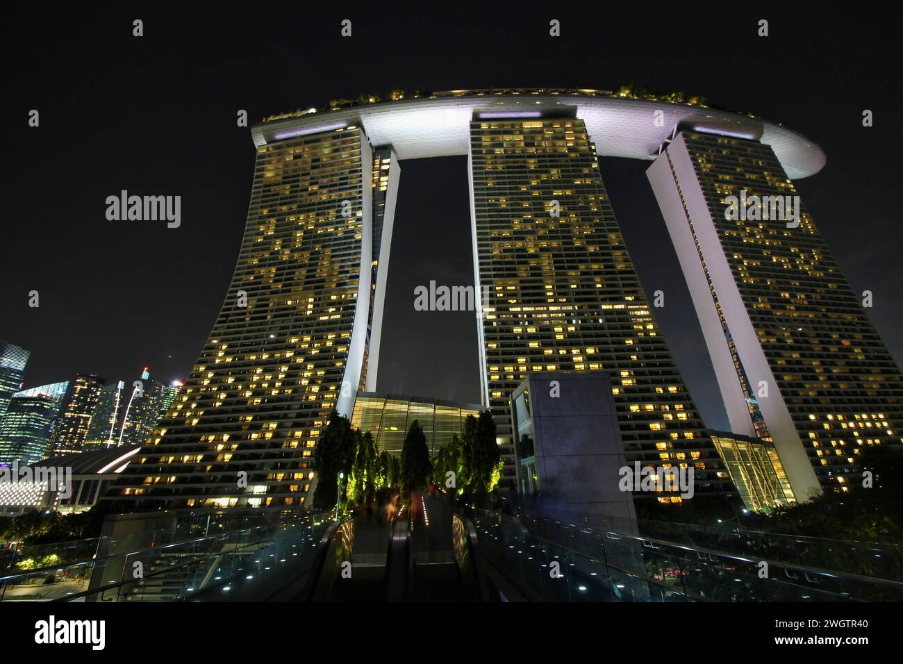 The triple towers of the Marina Bay Sands hotel are fully illuminated ...
