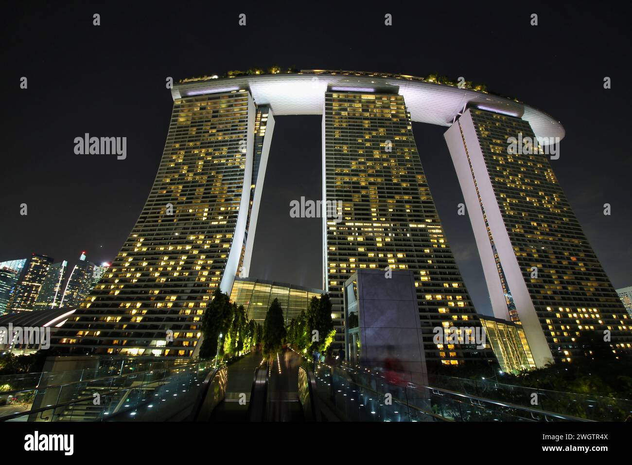 The triple towers of the Marina Bay Sands hotel are fully illuminated ...
