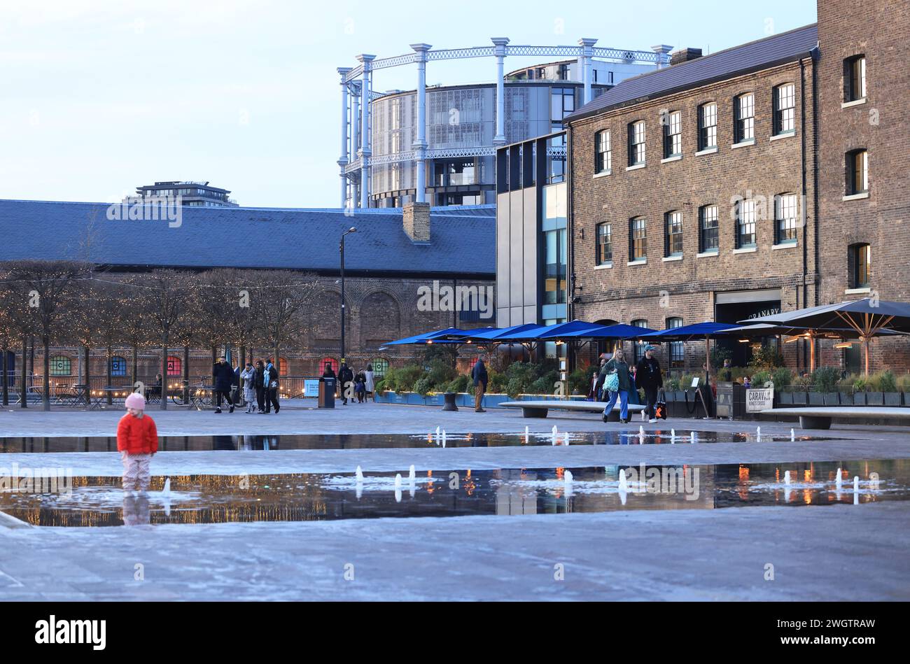 Fountains on Granary Square at Kings Cross in late afternoon winter ...