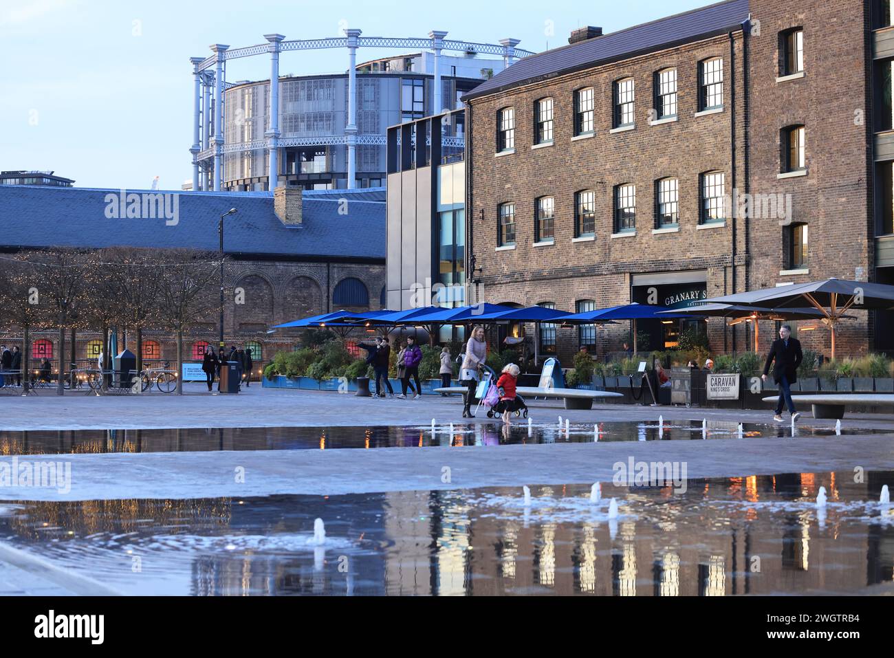 Fountains on Granary Square at Kings Cross in late afternoon winter ...
