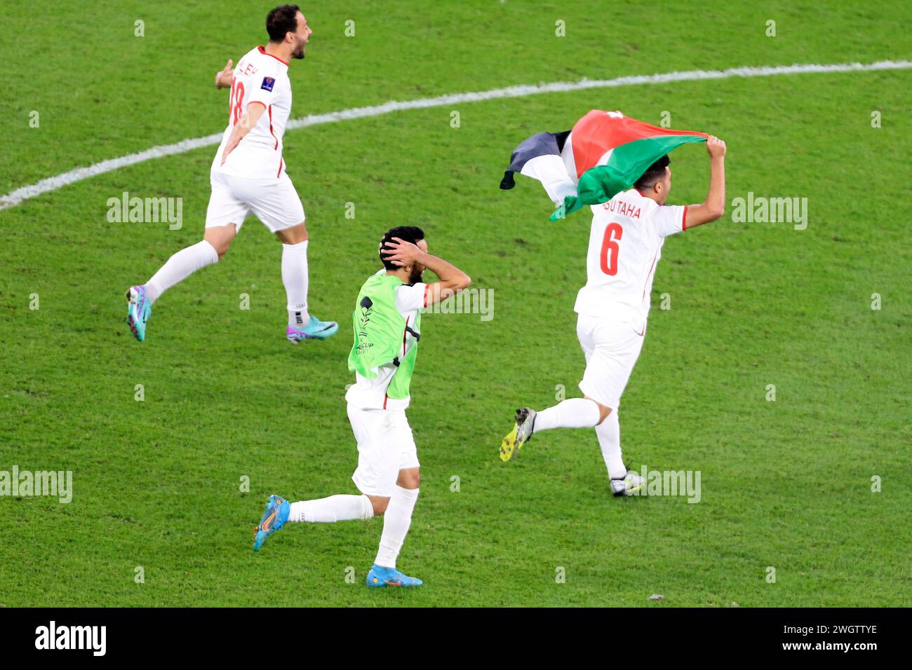 Jordan's Mohammad Abu Taha, right, runs with his cuntry's flag after winning during the Asian ...