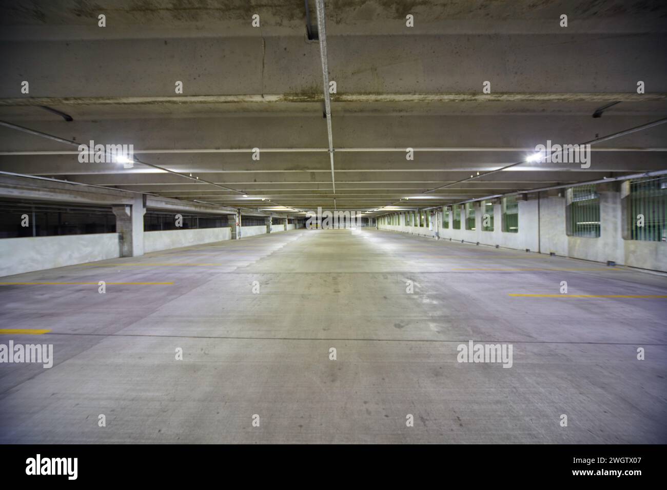 Empty Urban Parking Garage with Fluorescent Lighting, Symmetrical ...