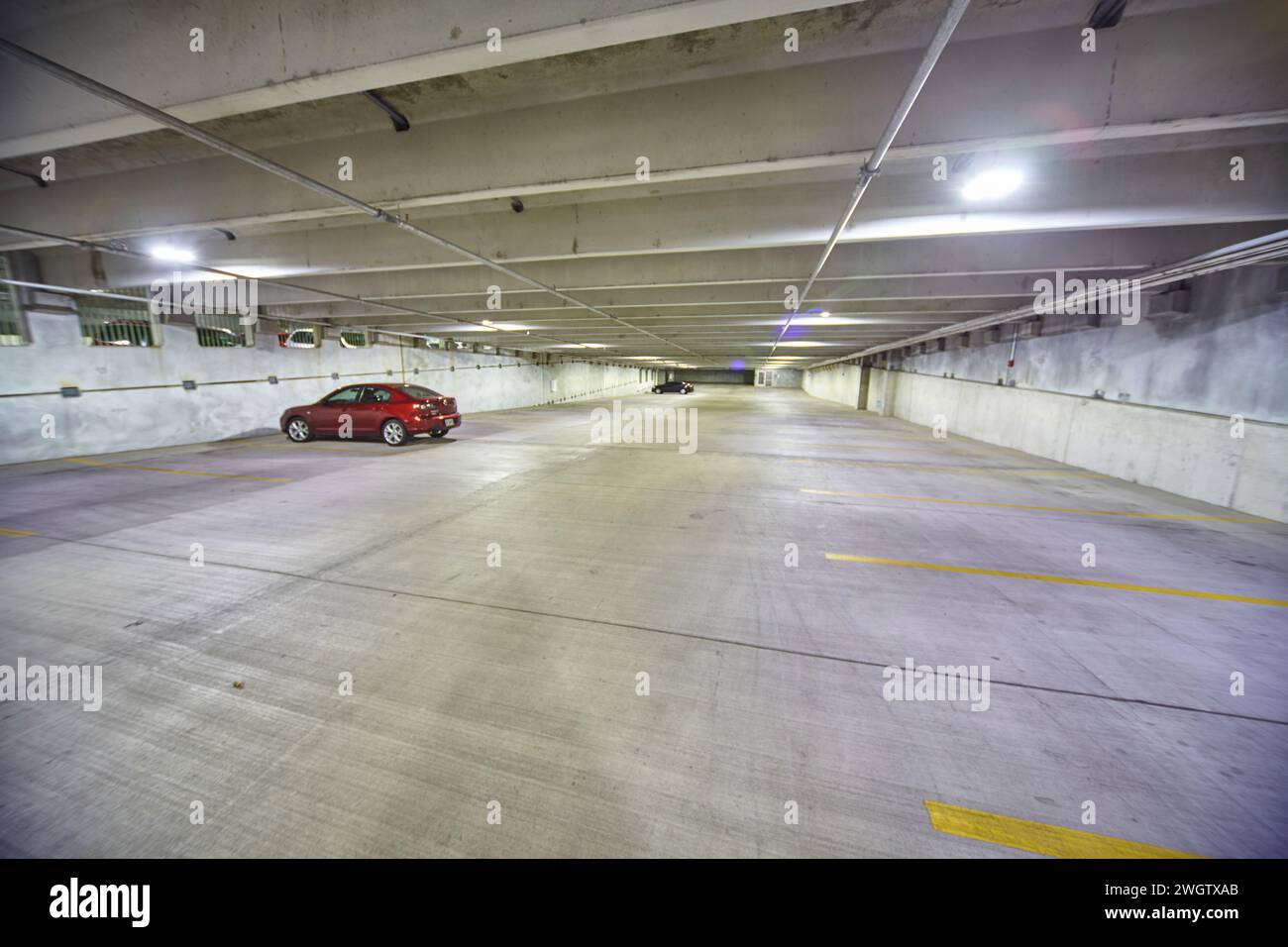 Solitary Red Car in Empty Indoor Parking Garage at Night Stock Photo ...