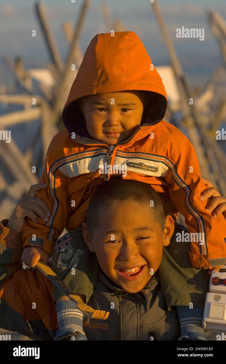 Eskimo Inupiat kids playing at camp on a sandspit along Demarcation bay ...