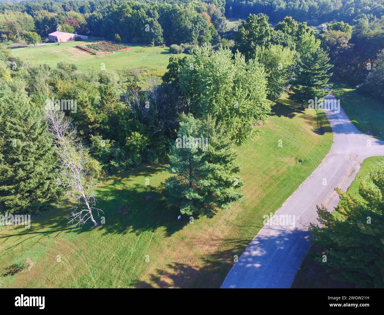 Aerial View of Serene Rural Landscape with Red Barn and Garden Path ...