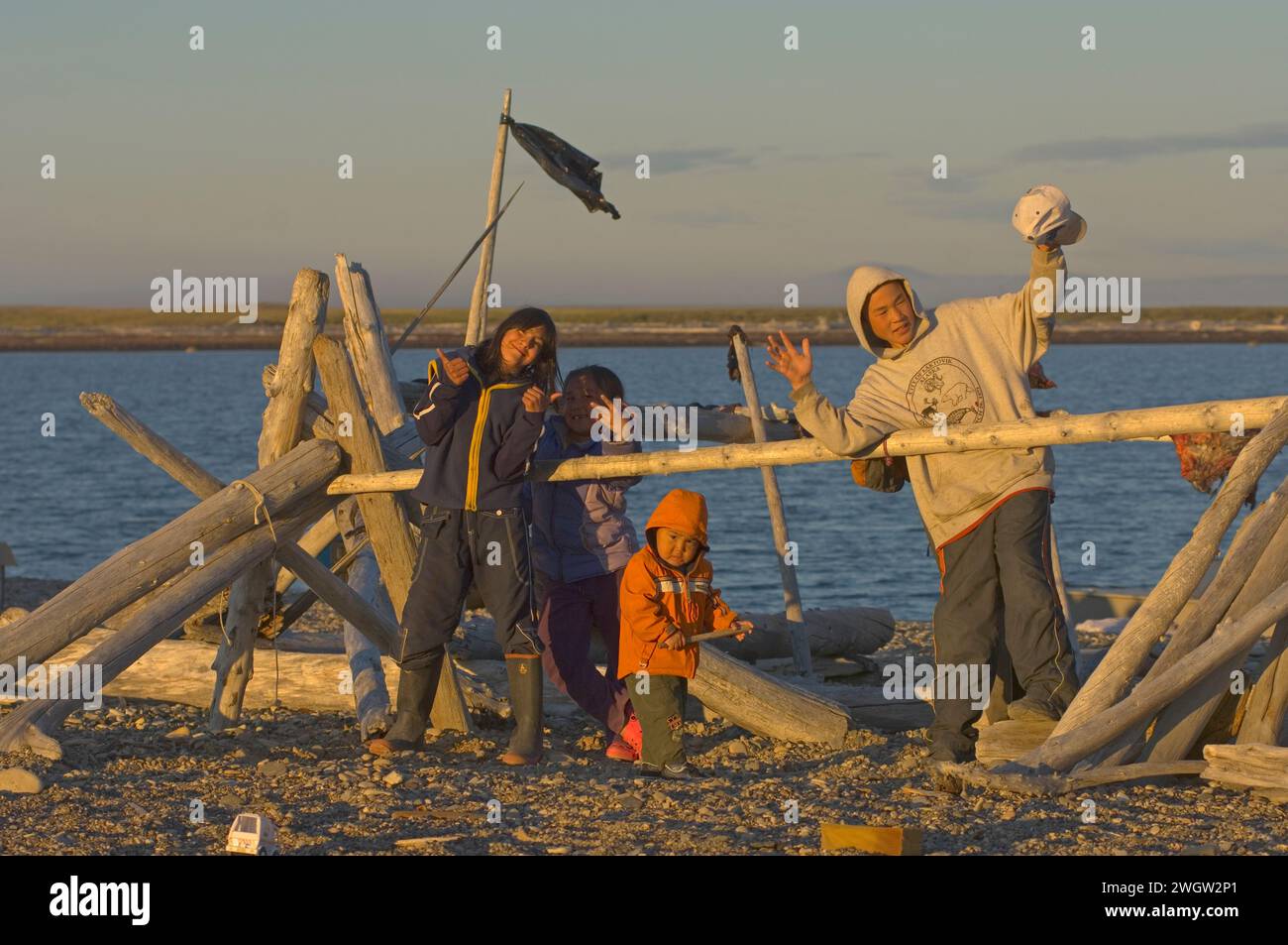 Eskimo Inupiat kids playing at camp on a sandspit along Demarcation bay ...