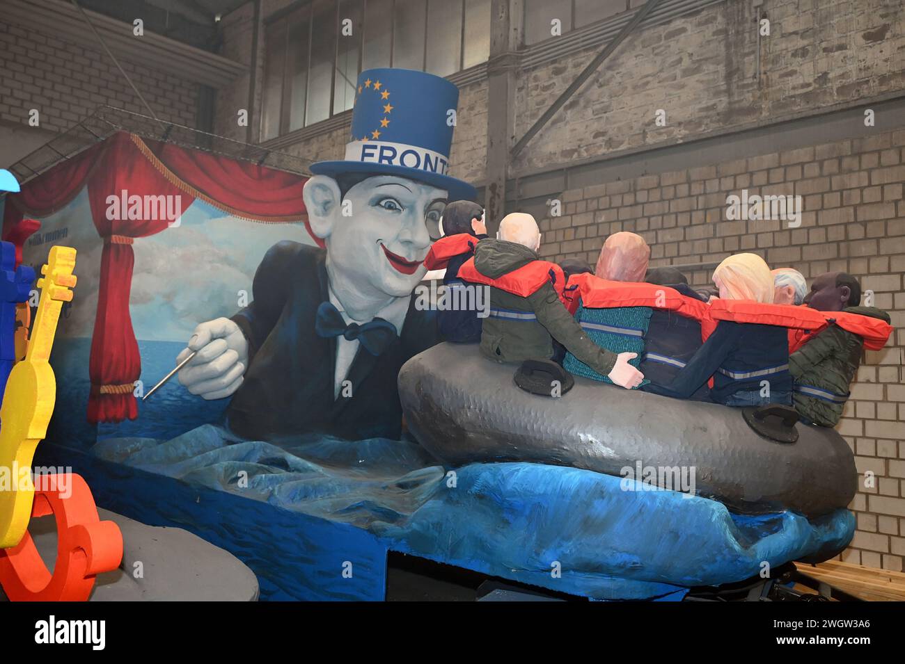 Cologne, Germany. 06th Feb, 2024. A Frontex and boat refugees motif float stands in a hall at ...