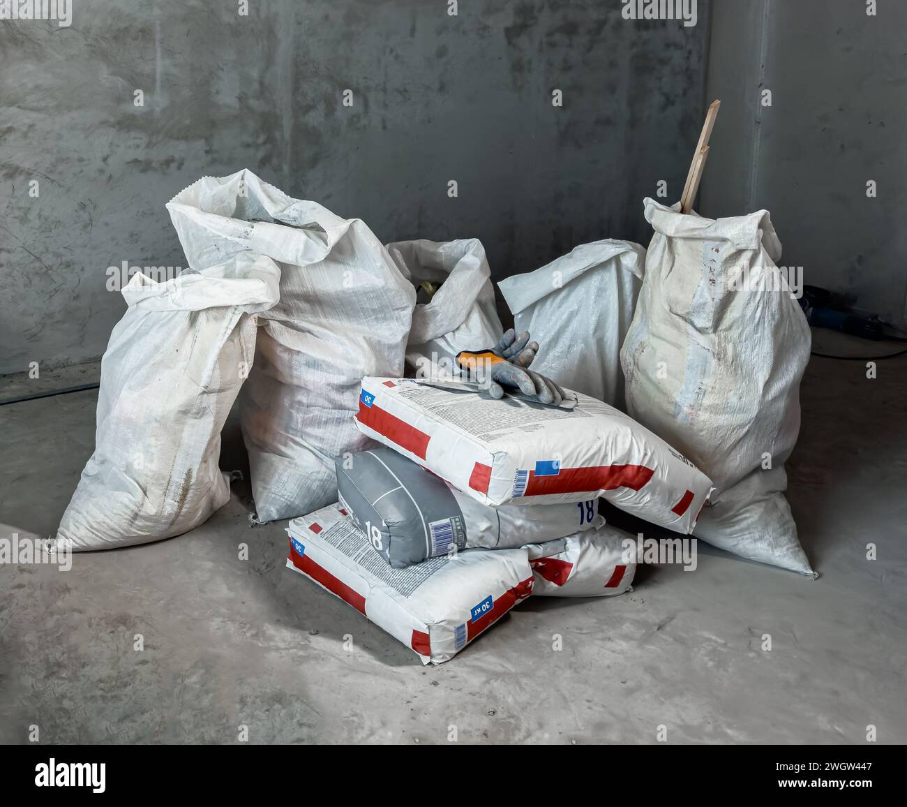 Building garbage, waste bags in empty room, apartment during renovation ...